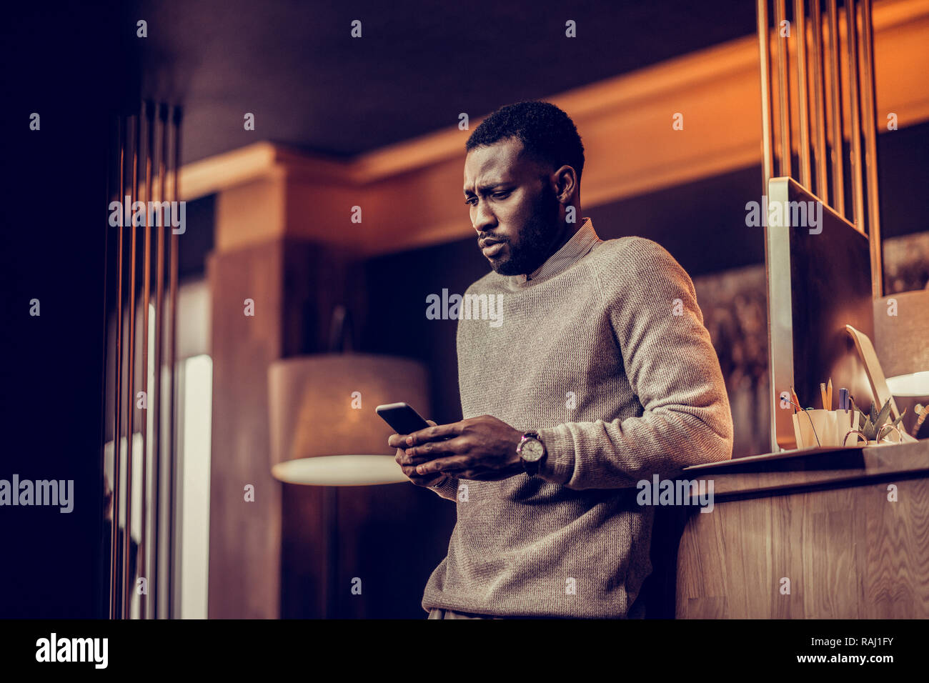 Serious young male person creating answer on message Stock Photo - Alamy