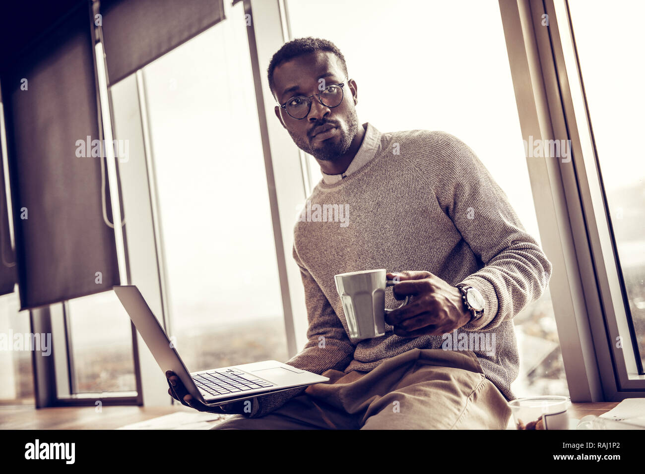 Concentrated international man being deep in thoughts Stock Photo - Alamy