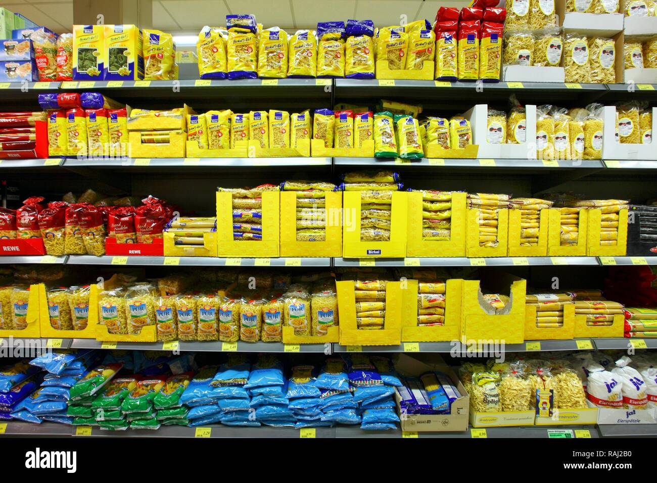 Shelves with various types of pasta, self-service, food department ...
