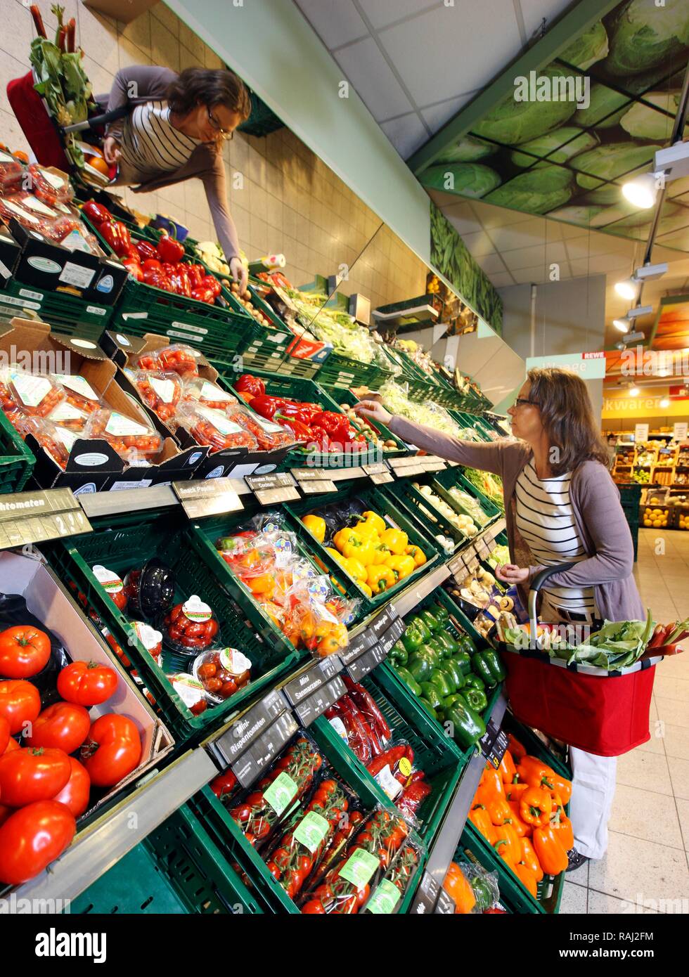 Woman shopping in the fruit and vegetable section of a self-service ...