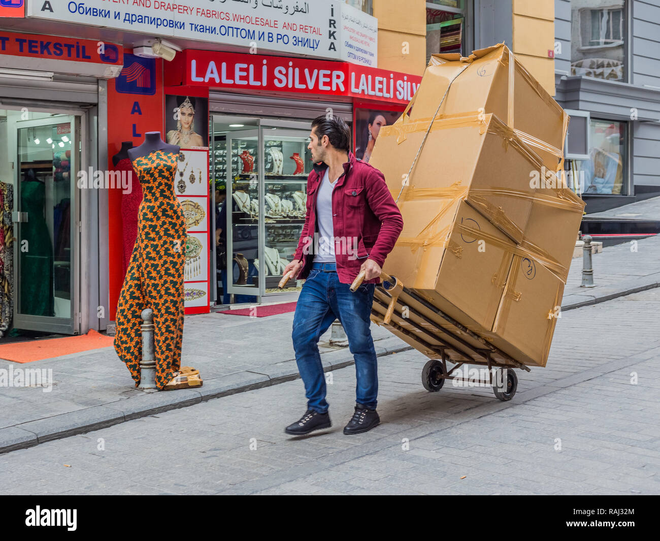 Man pulling trolley hi-res stock photography and images - Alamy