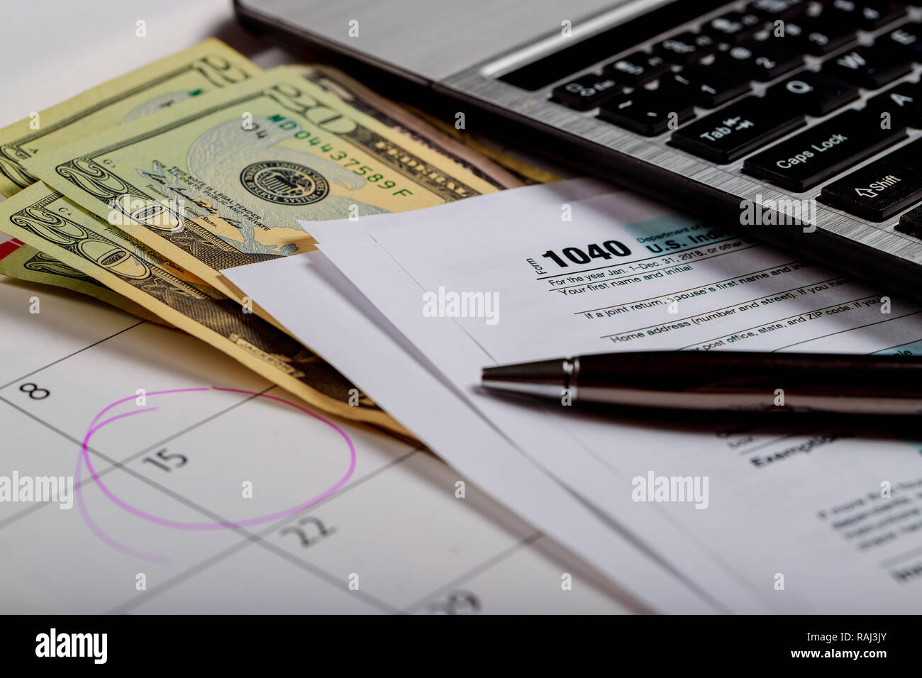Top veiw USA IRS tax form 1040 and a calendar. U S dollars selective ...