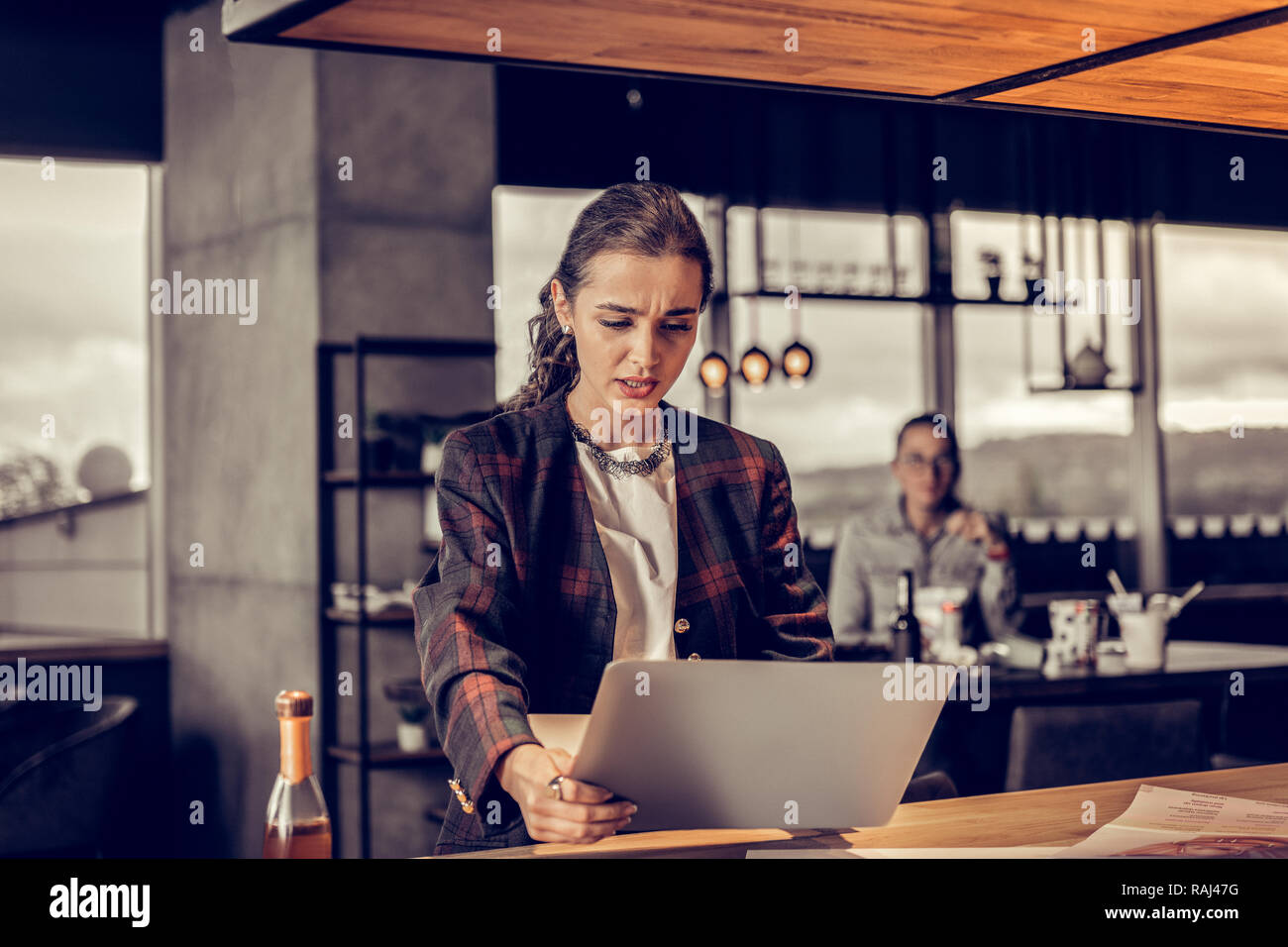 Emotional young woman staring at screen of her computer Stock Photo - Alamy