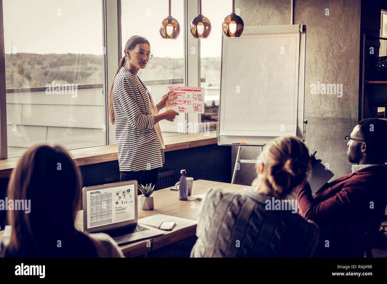 Professional speaker presenting her project work in office Stock Photo ...