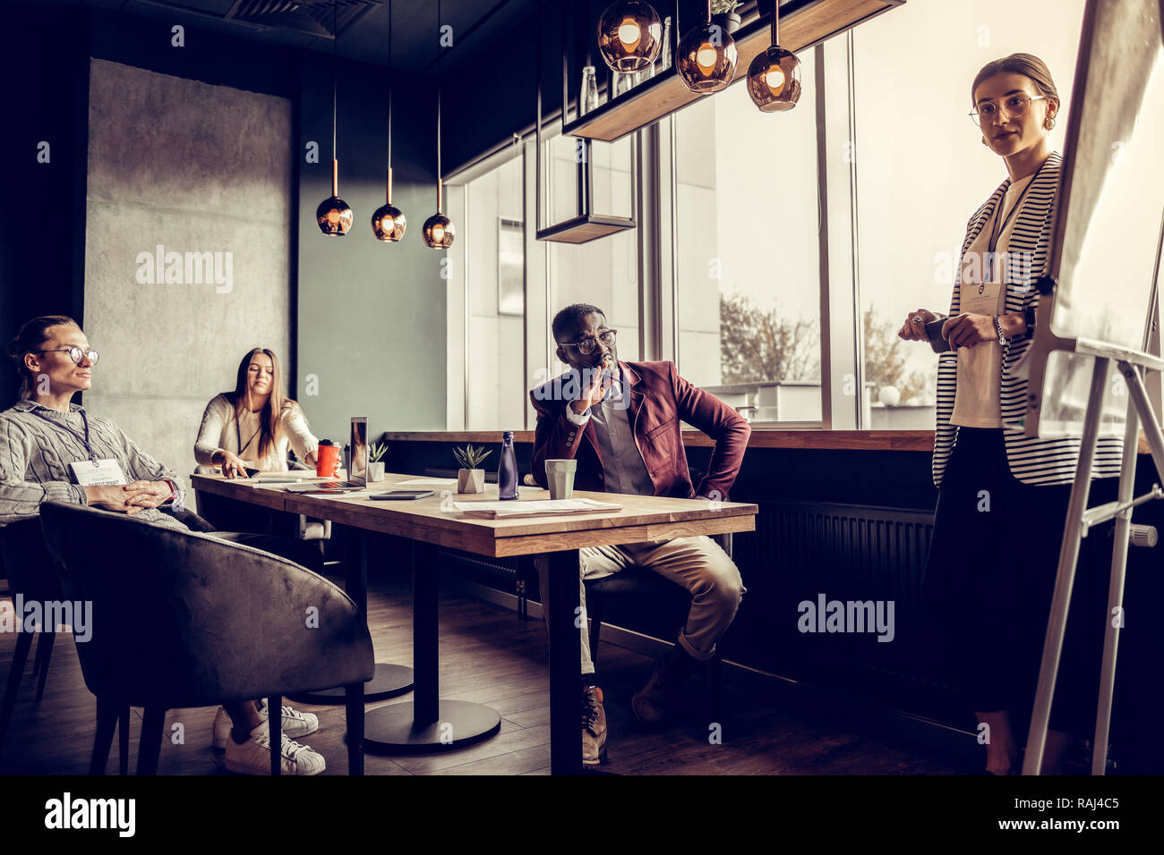 Group of pleased people that looking at board Stock Photo - Alamy