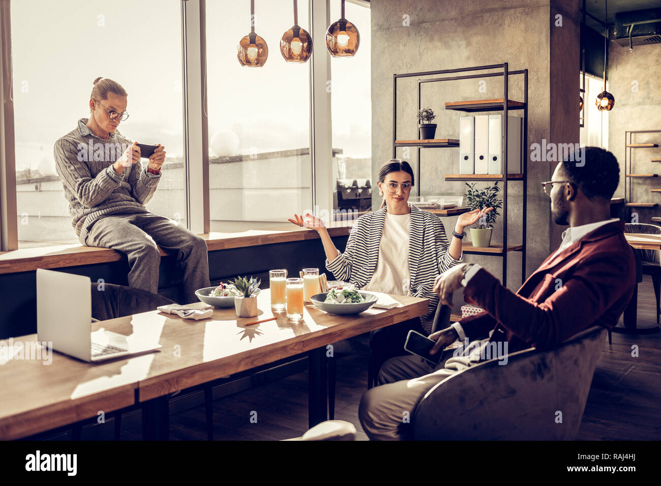 Emotional female person talking to her partners Stock Photo - Alamy
