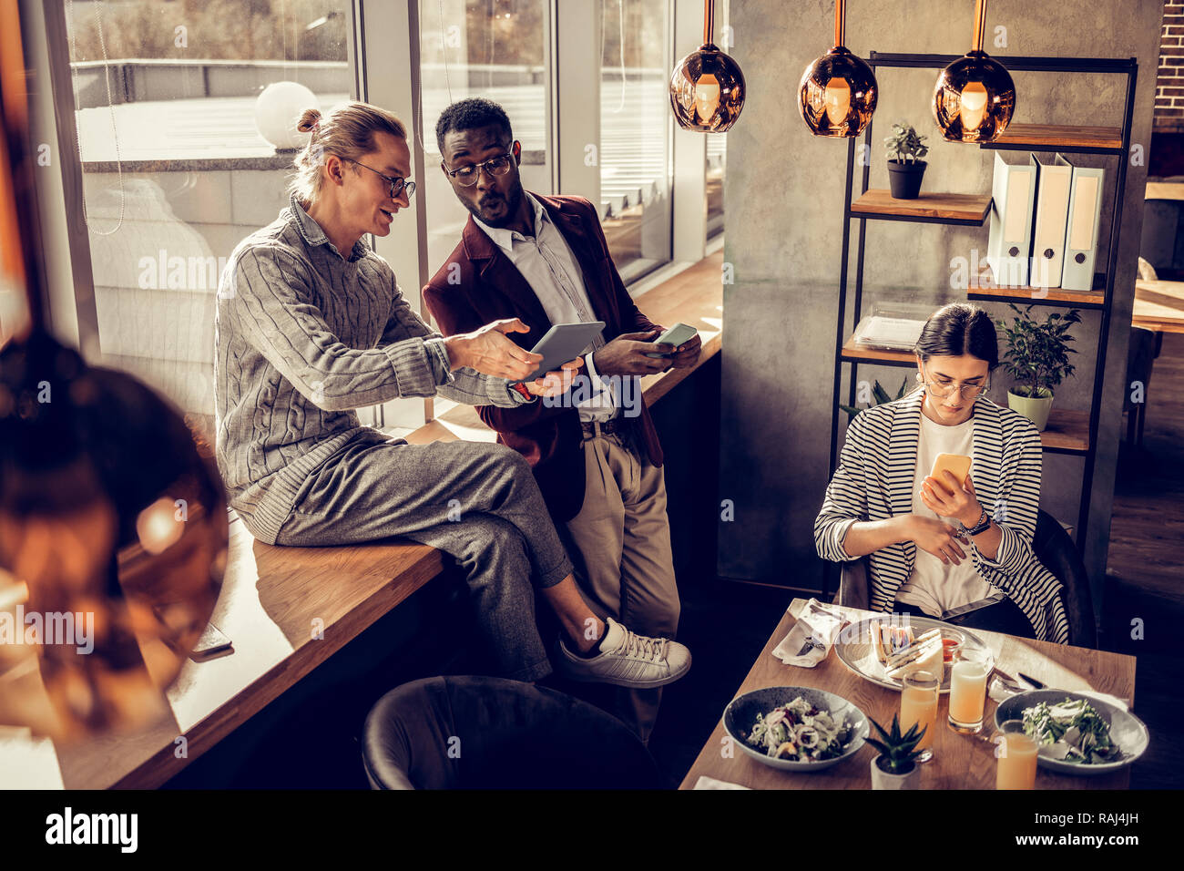 Emotional international male person staring at tablet Stock Photo - Alamy