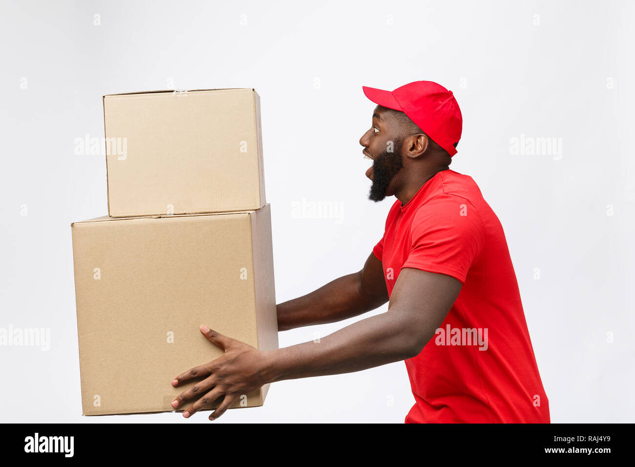 Portrait of delivery african american man in red shirt. he lifting ...
