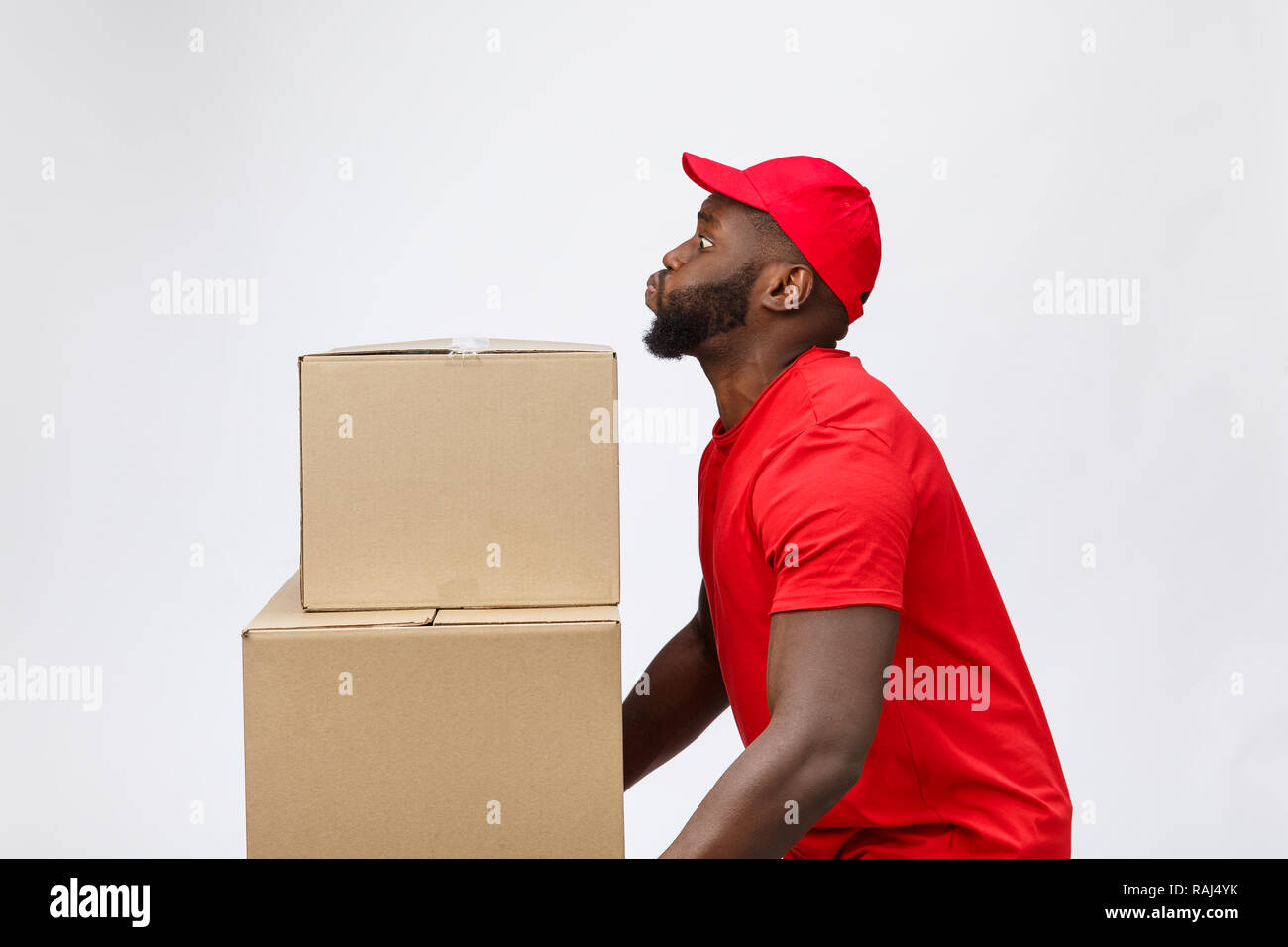 Man lifting heavy boxes hi-res stock photography and images - Alamy