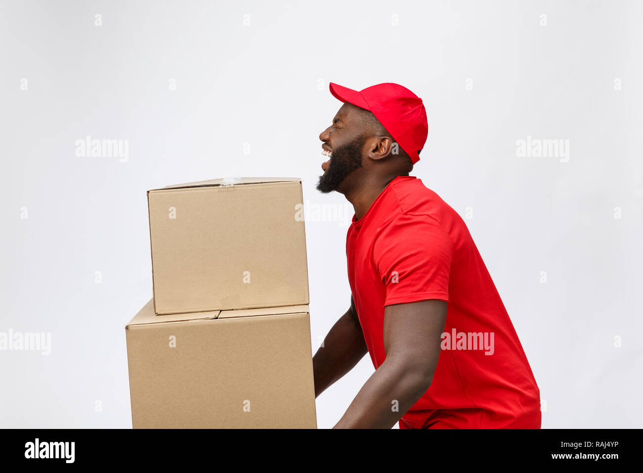 Portrait of delivery african american man in red shirt. he lifting ...