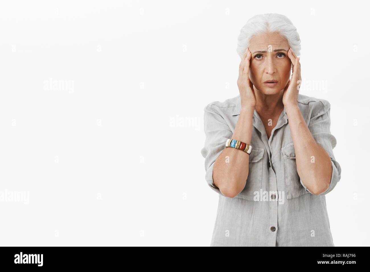 Poor senior woman suffering migraine. Troubled gloomy granny with grey ...