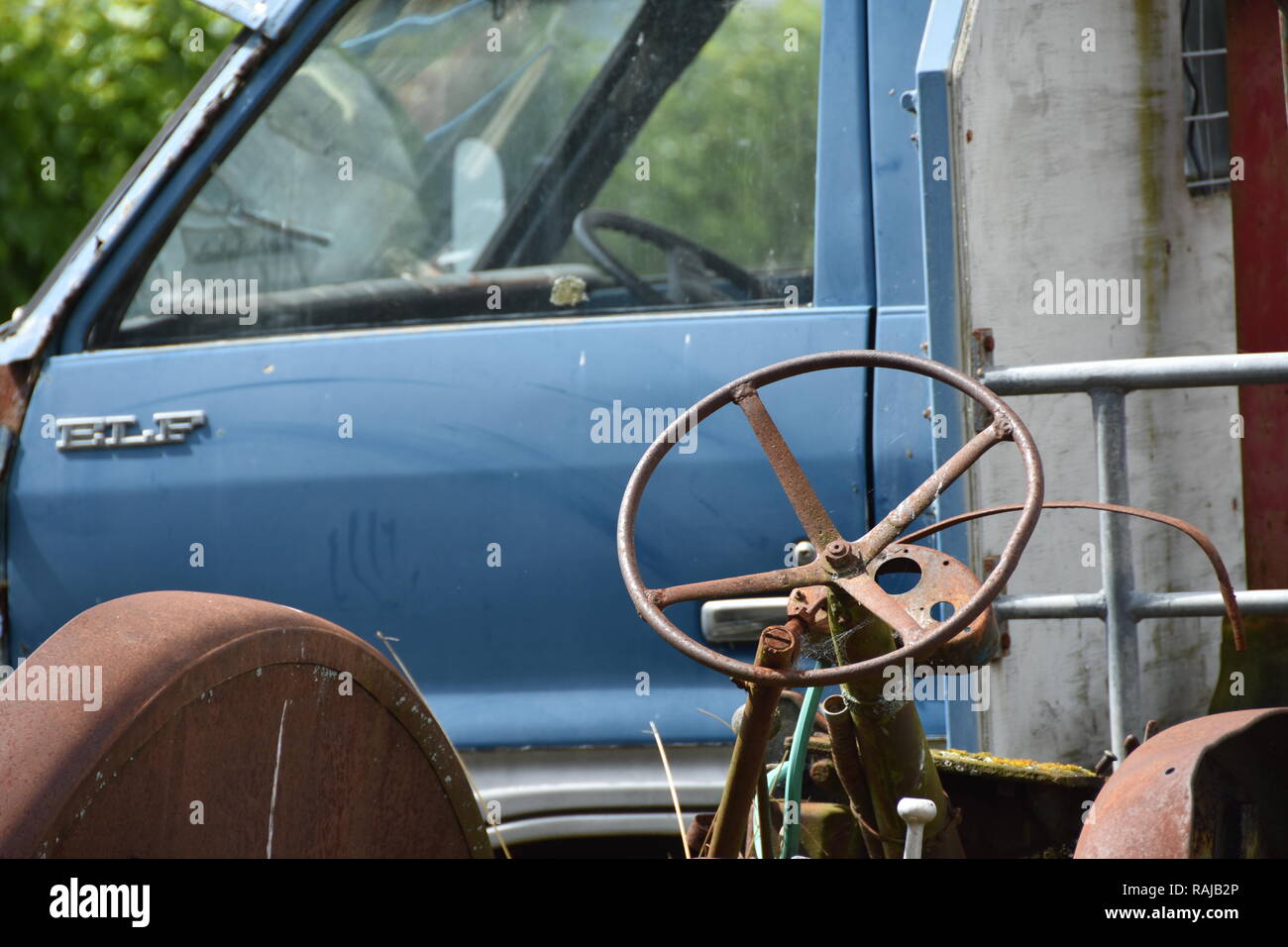 Van and tractor in a small wrecking yard next to a vineyard Stock Photo ...