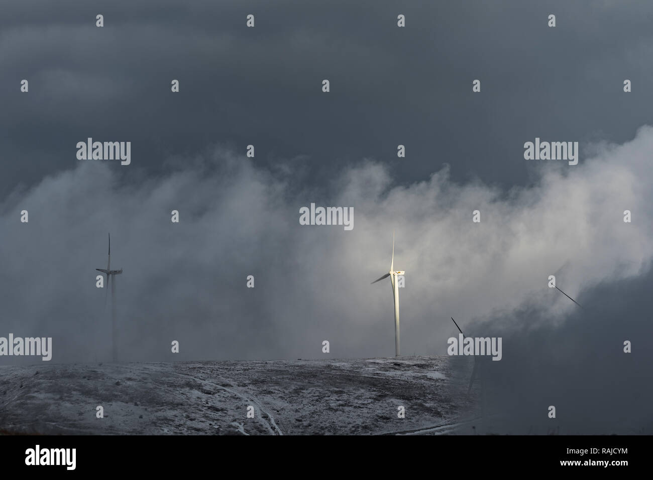 Winter landscape with wind turbines and clouds on a snow covered ...