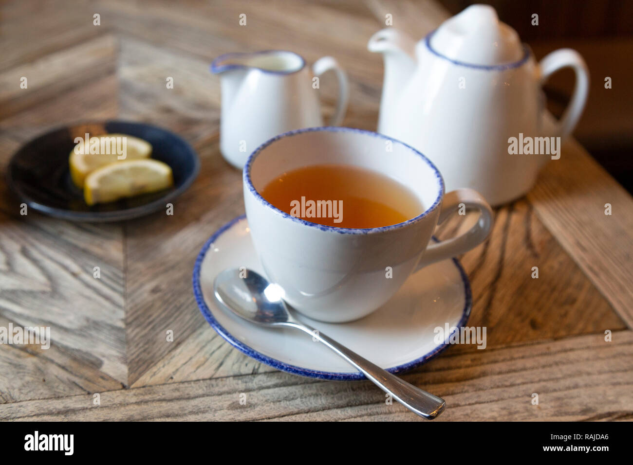 Earl Grey tea served with pieces of lemon. The tea is served from a ...