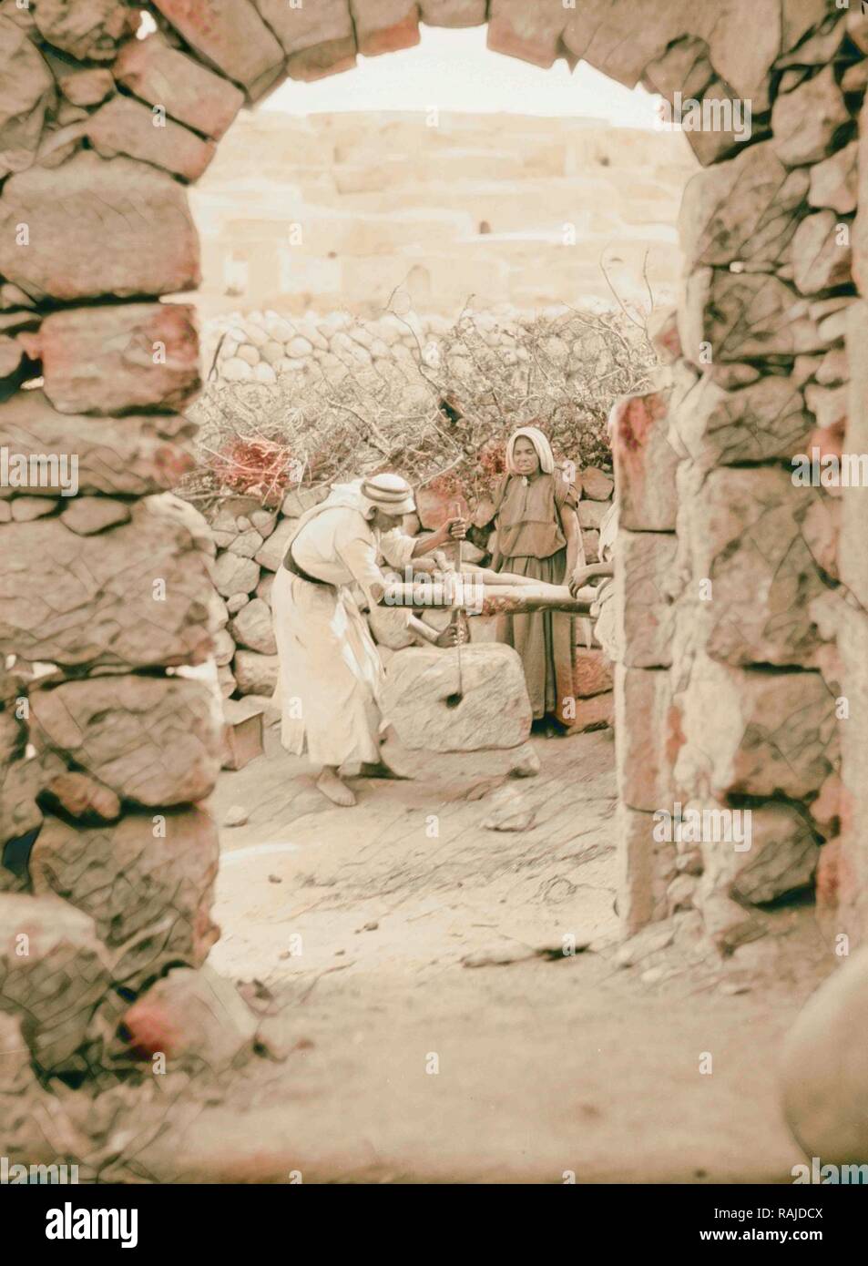 Olive crushing and pressing. Process of applying the weight. Scene ...