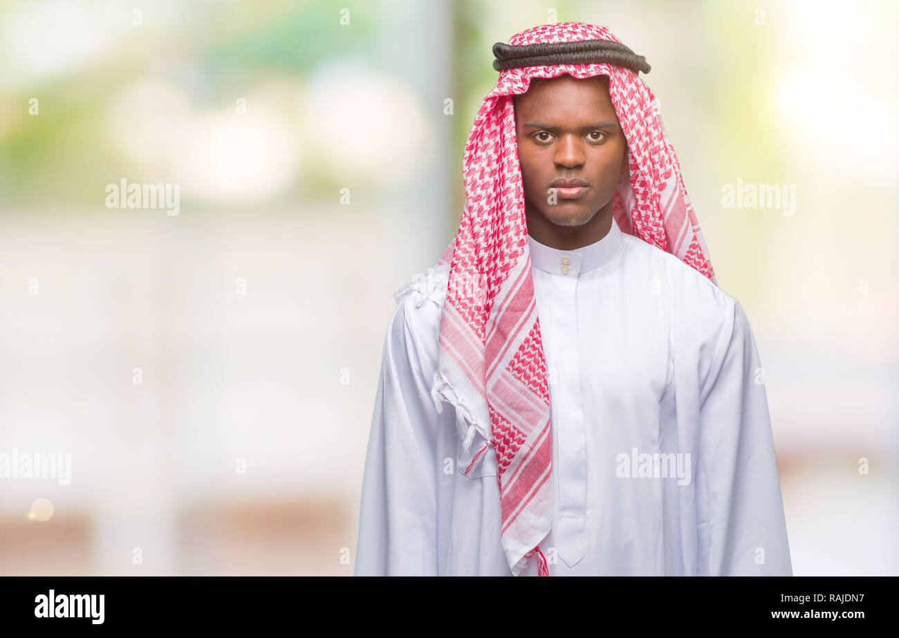 Young arabic african man wearing traditional keffiyeh over isolated ...