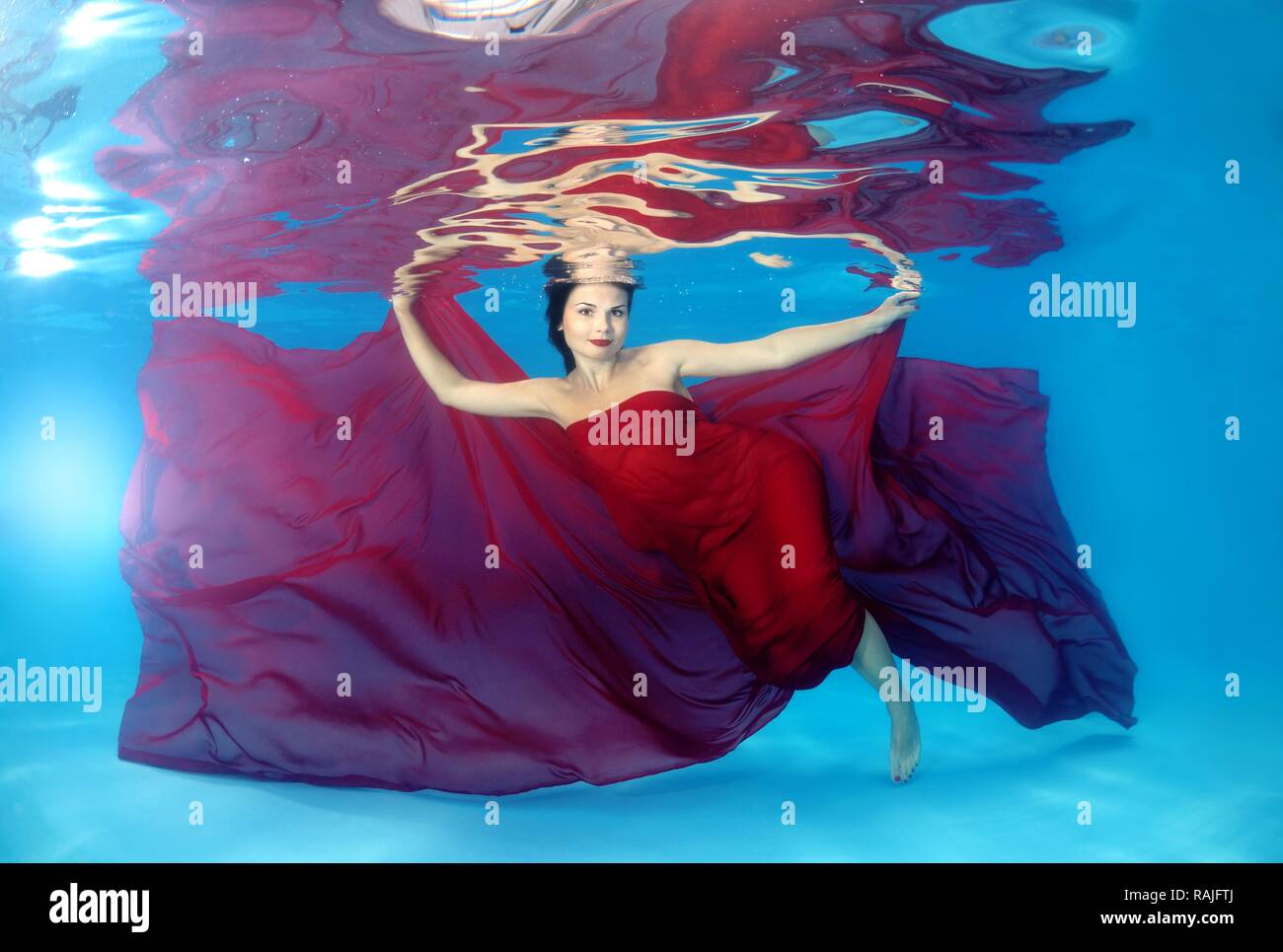 Woman presenting underwater fashion in a pool Stock Photo - Alamy