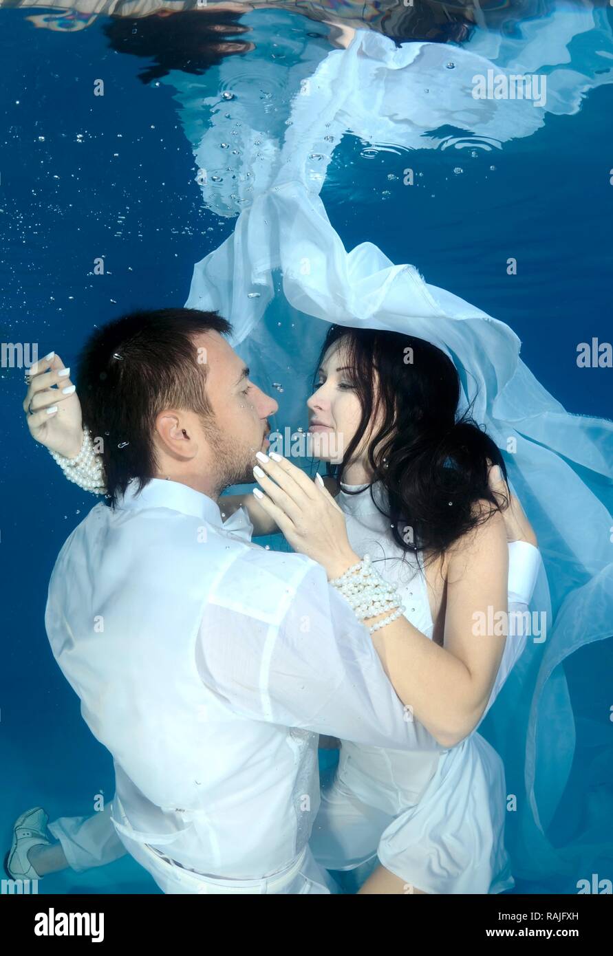Bride and groom, underwater wedding in a pool Stock Photo - Alamy
