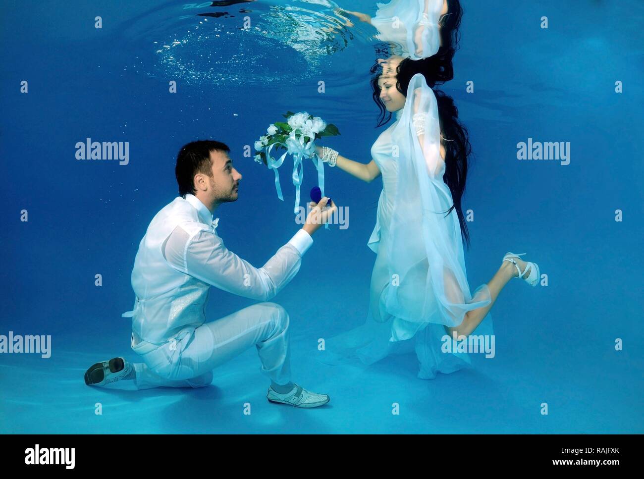 Bride and groom, underwater wedding in a pool Stock Photo - Alamy