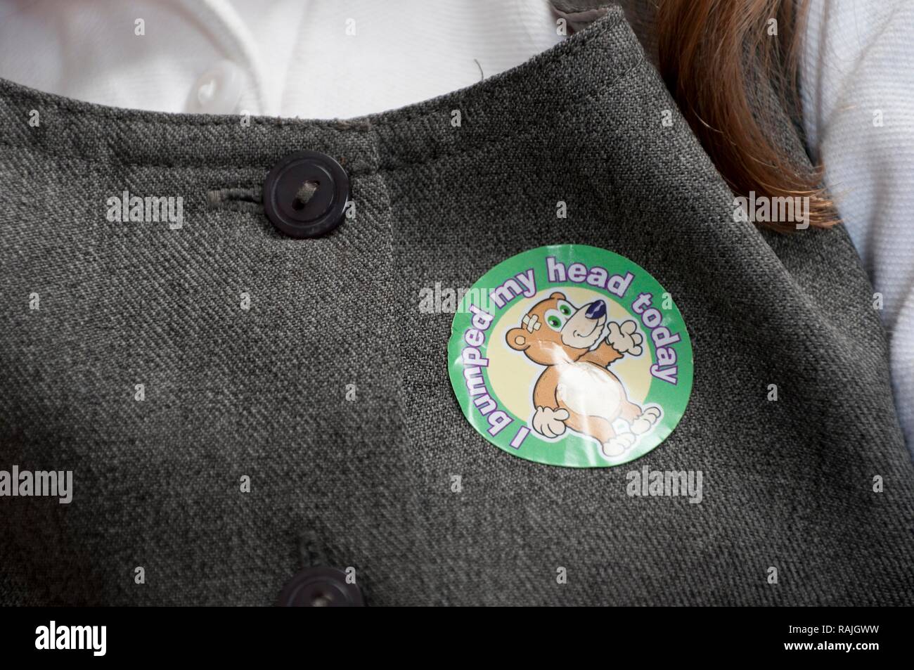 Bumped head sticker on uniform of primary school pupil Stock Photo - Alamy