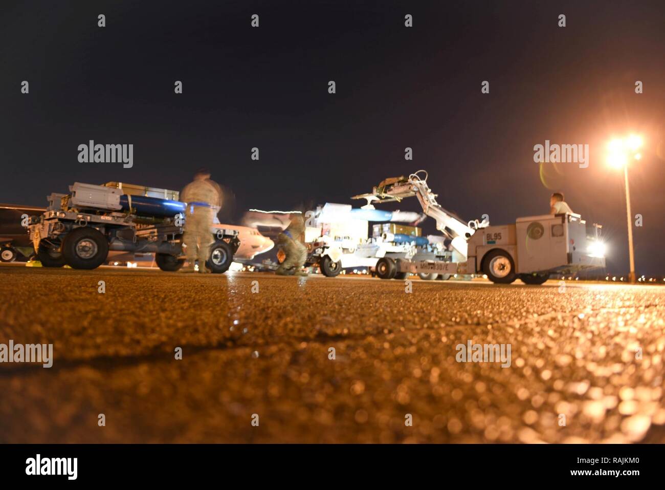 A weapons load crew begins the process of loading bombs onto a B-52 ...