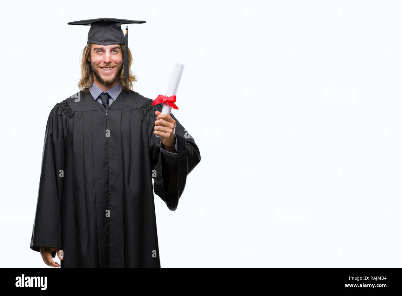 Young handsome graduate man with long hair holding degree over isolated ...