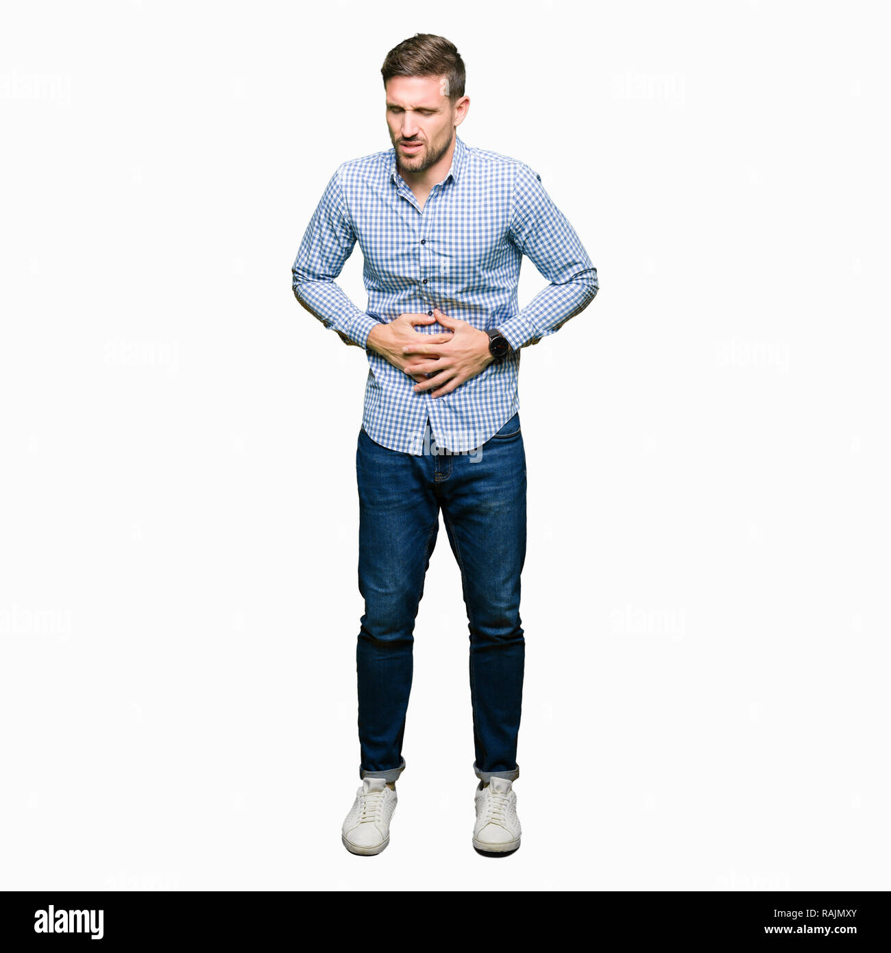 Handsome business man with blue eyes with hand on stomach because ...