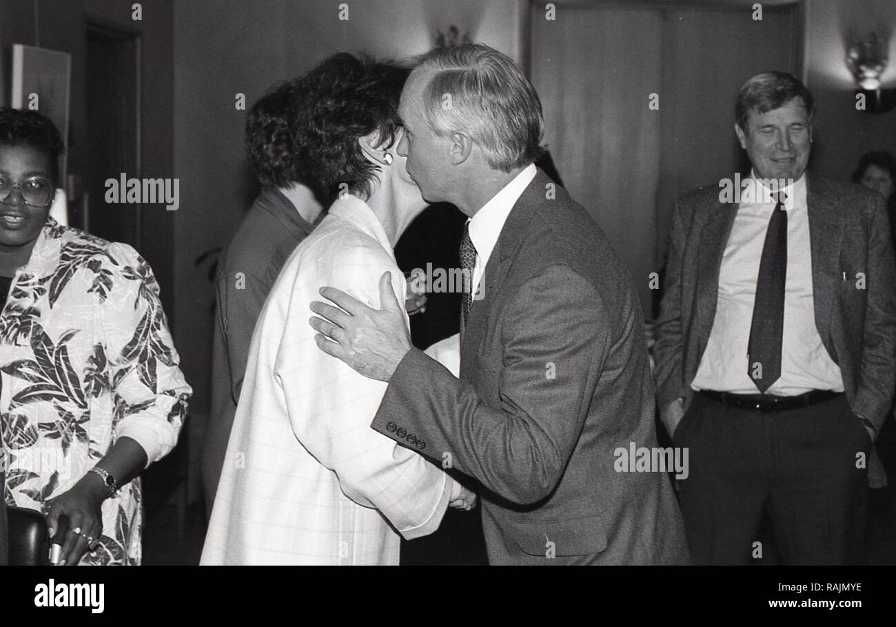 CAROL ADELMAN GREETING MAN WITH A HAND SHACK AND A KISS Stock Photo - Alamy