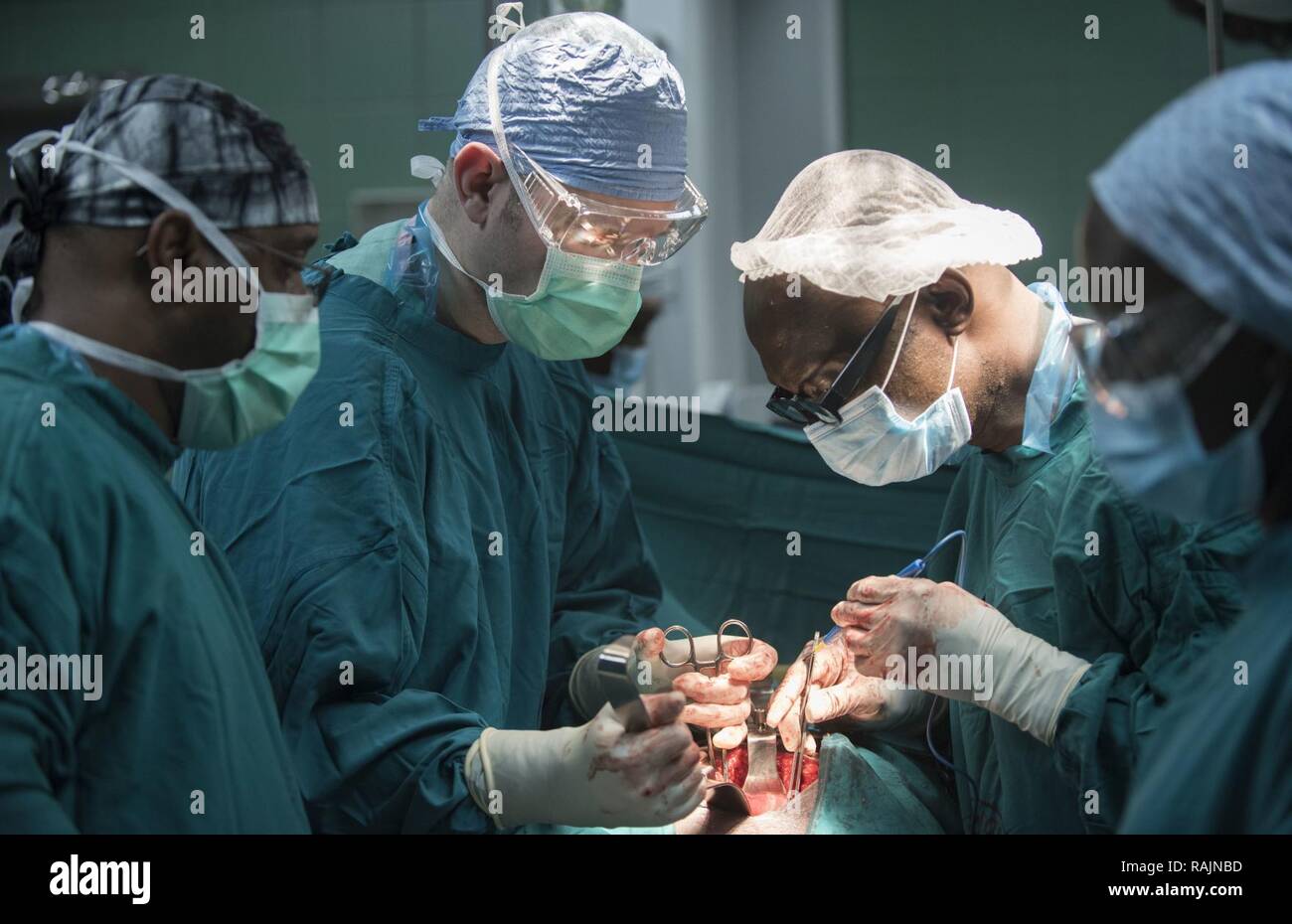 U.S. Army and Ghanaian medical professionals perform a radical ...