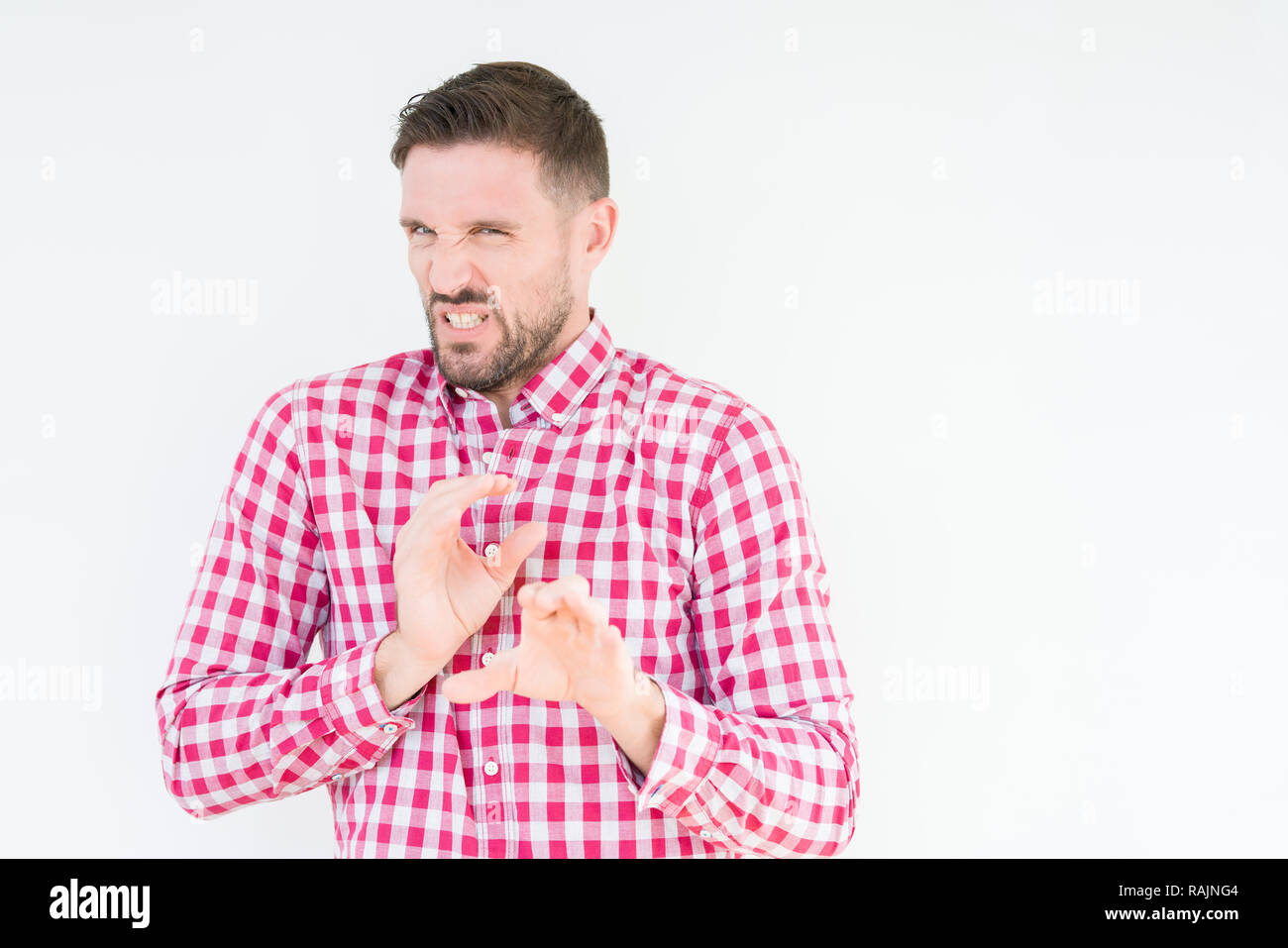 Young handsome man wearing shirt over isolated background disgusted ...