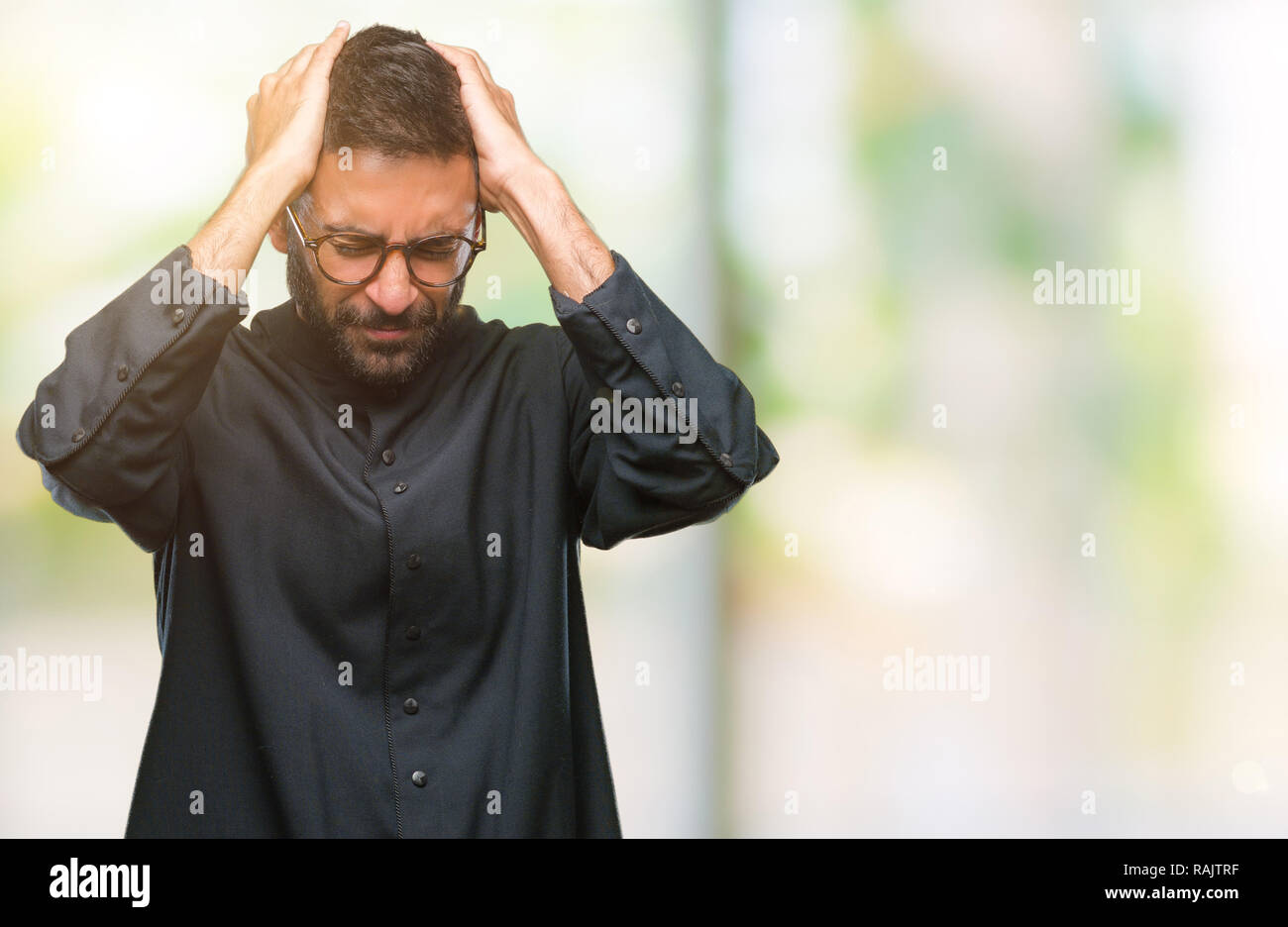 Adult hispanic catholic priest man over isolated background suffering ...