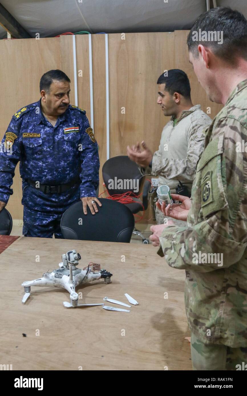 An Iraqi federal police operations officer (left) discusses ISIL ...