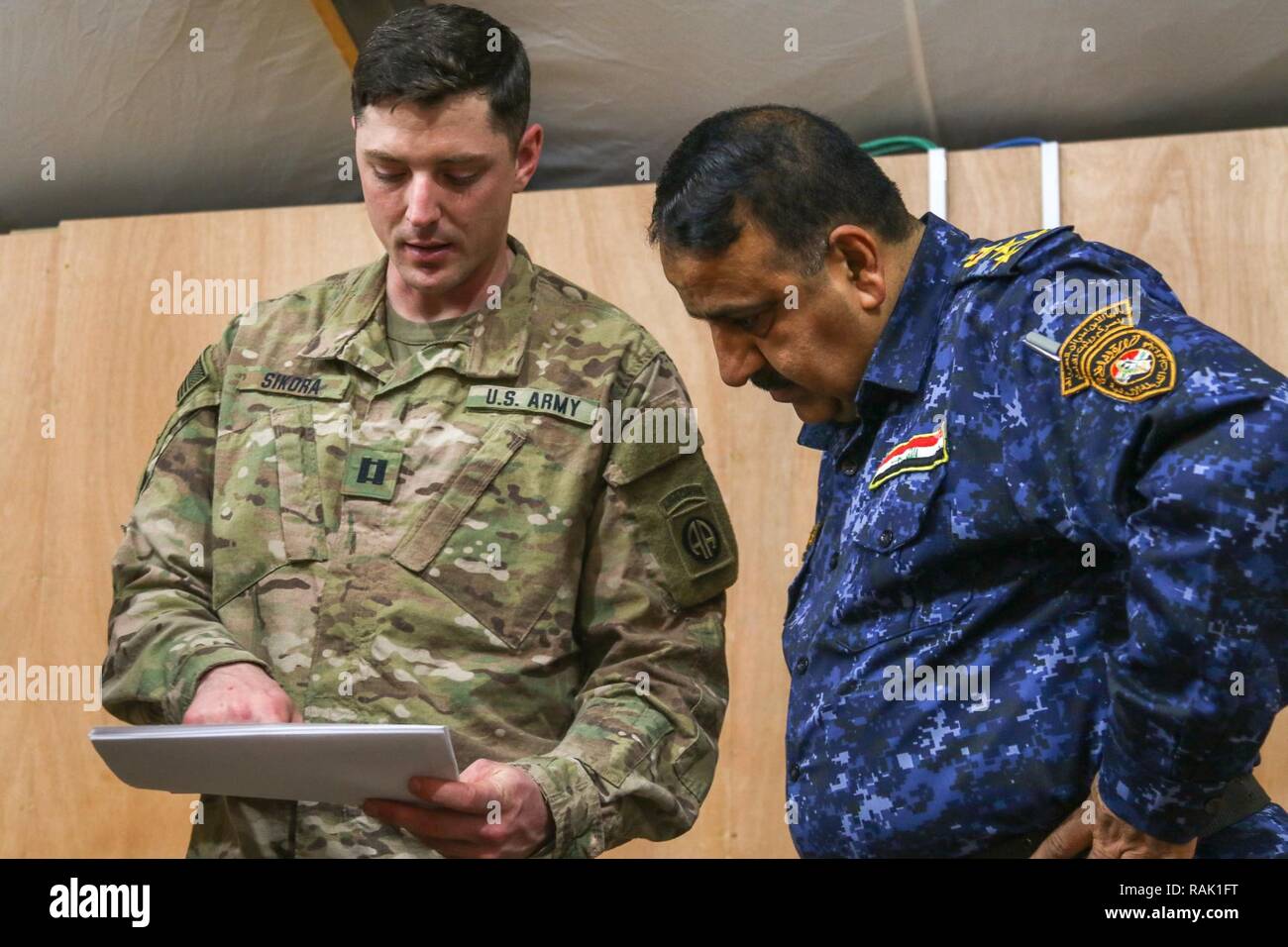 An Iraqi federal police operations officer (right) and U.S. Army Capt ...