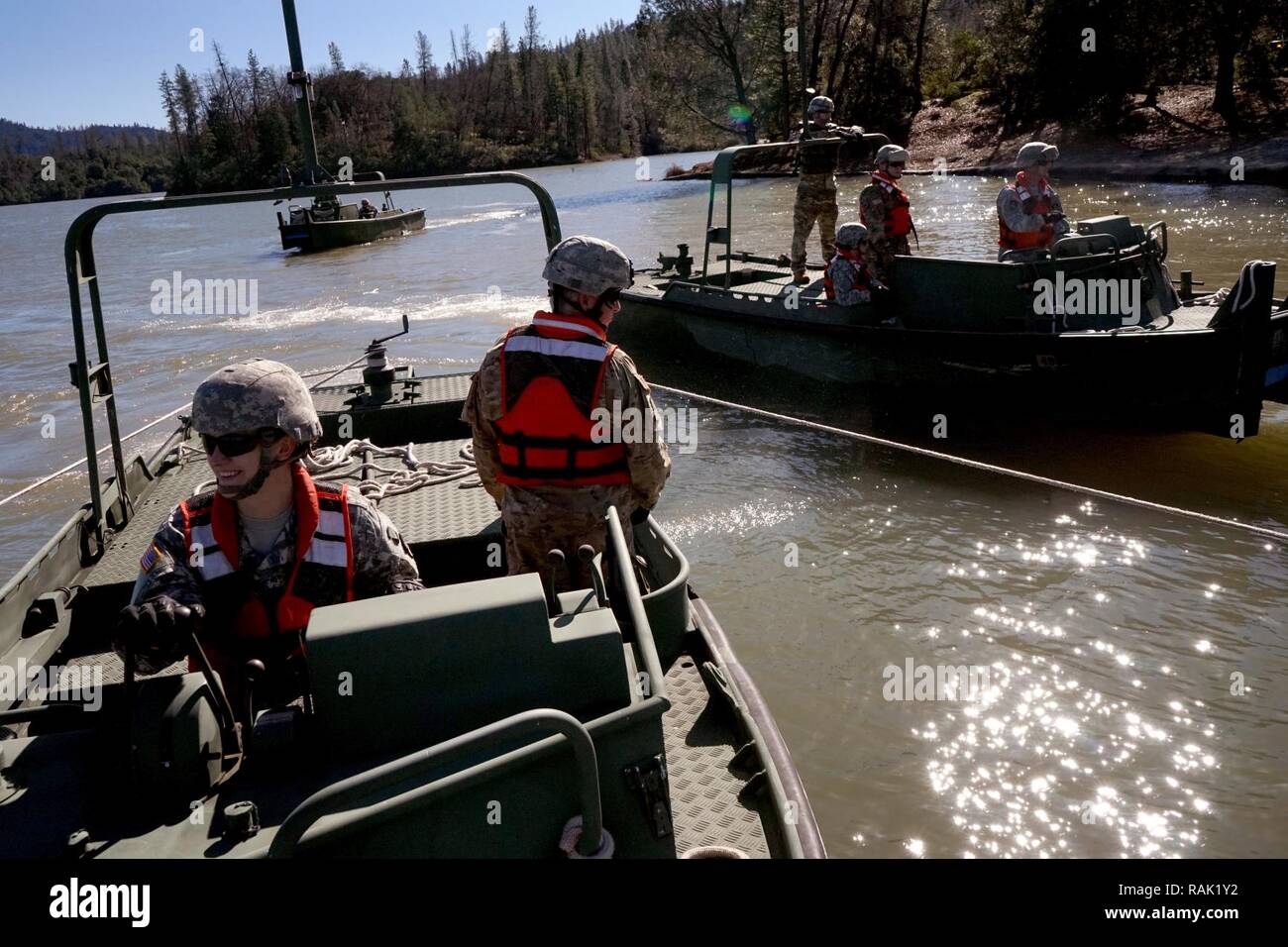 Soldiers from the 132nd Multi-Role Bridge Company guide segments of an ...