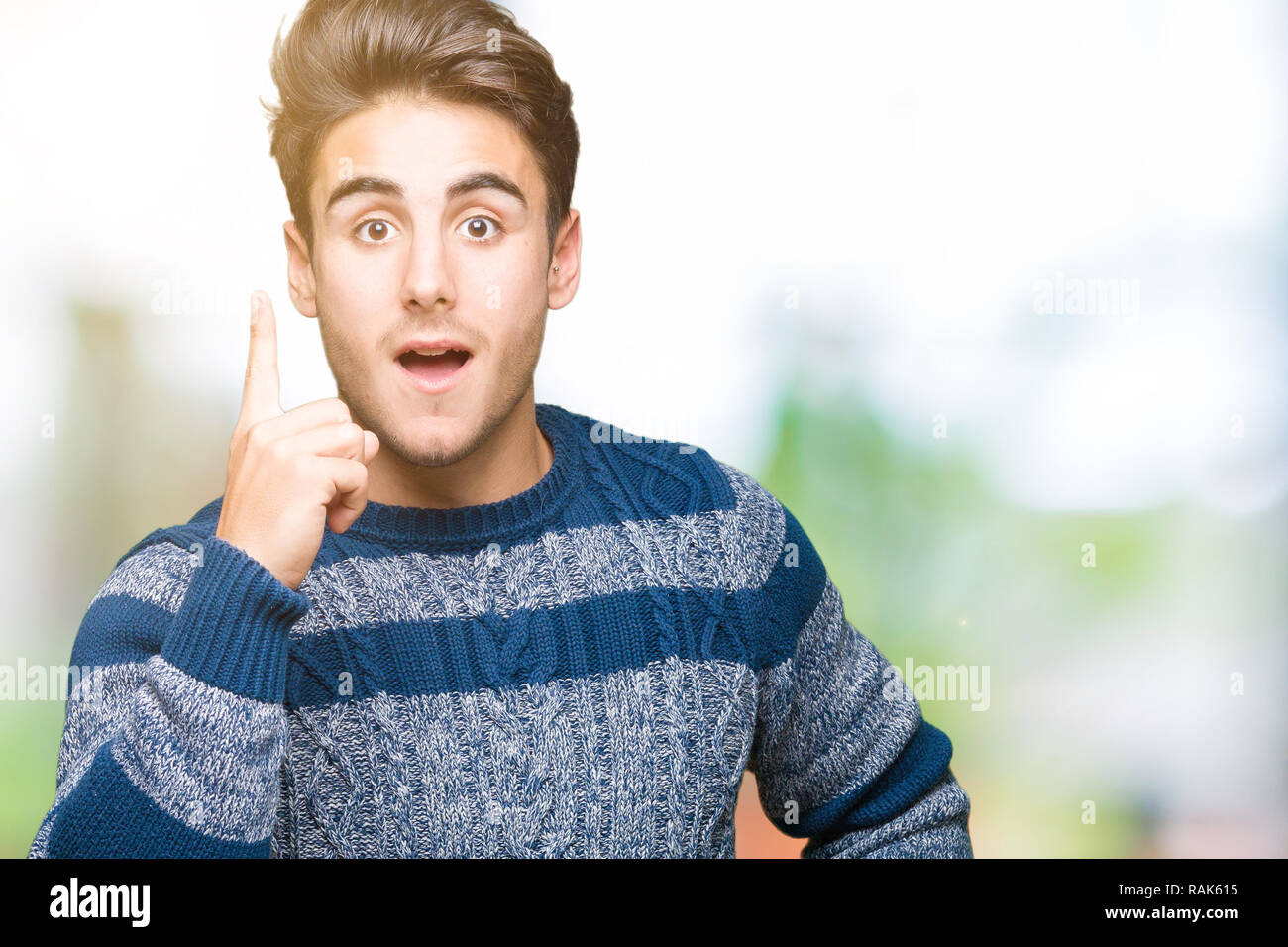 Young handsome man over isolated background pointing finger up with ...