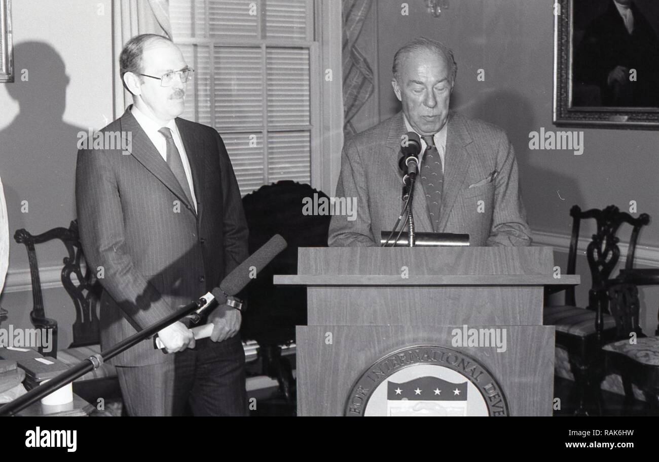 MAN AT THE PODIUM GIVING A SPEECH WITH A MAN STANDING NEXT TO HIM Stock ...