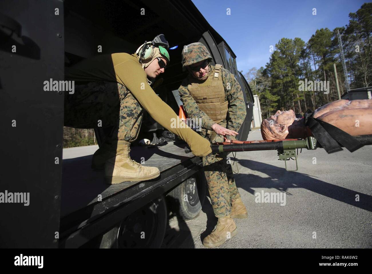 Corpsmen transport a notional patient onto an aircraft during a ...