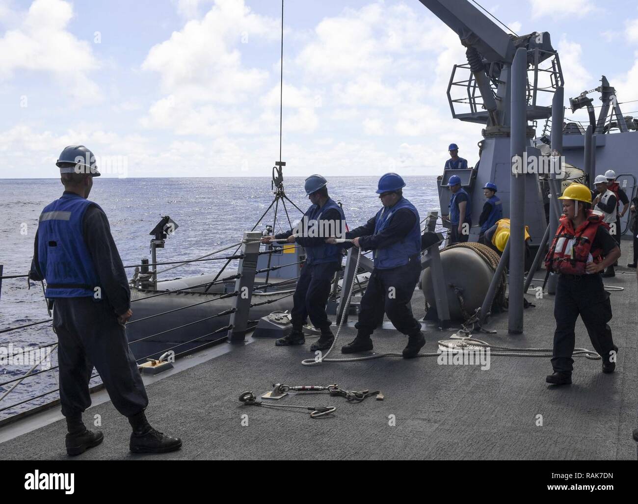 PACIFIC OCEAN (Feb. 13, 2017) Sailors lower a rigid hull inflatable ...