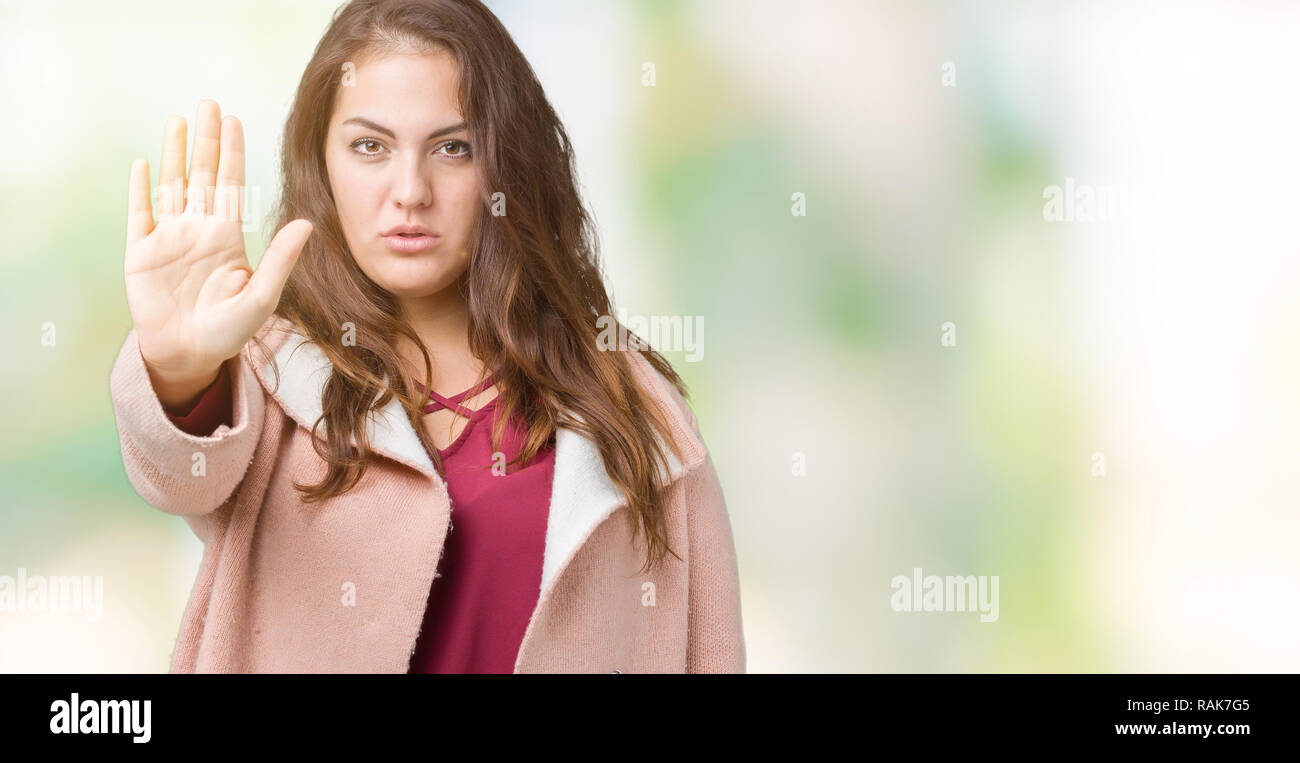 Beautiful plus size young woman wearing winter coat over isolated ...