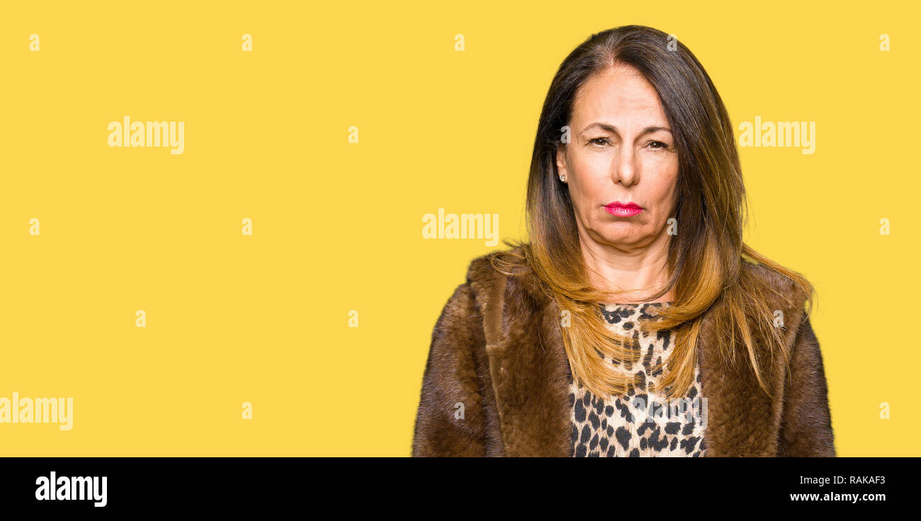 Beautiful middle age elegant woman wearing mink coat depressed and ...