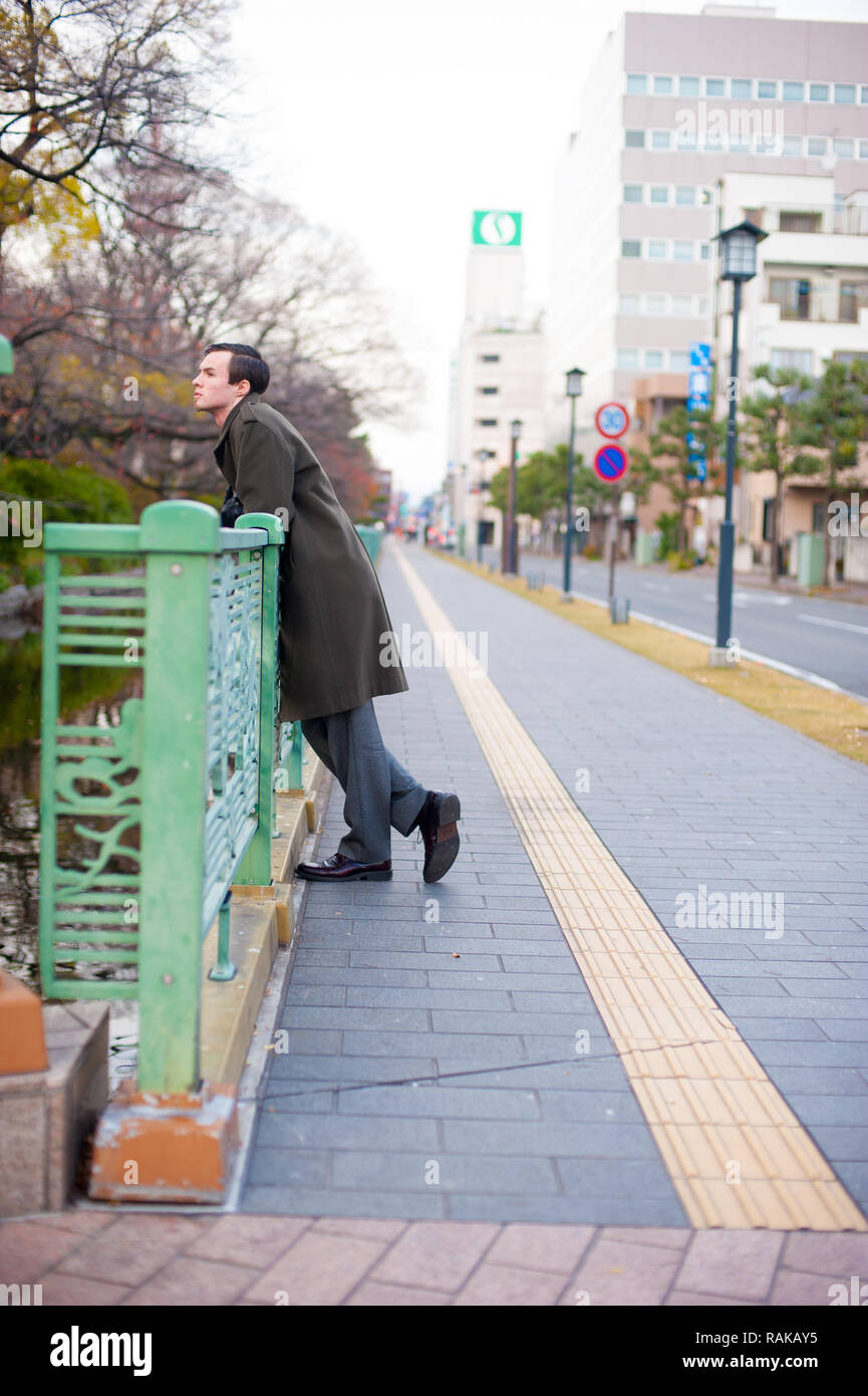 Caucasian male model poses for pictures on the street Stock Photo - Alamy