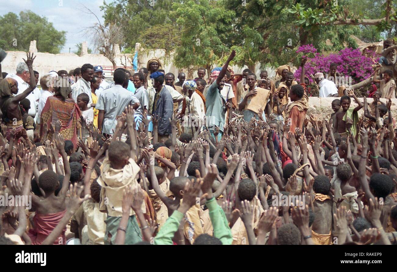 CHILDREN GATHERED SITTING RAISING THEIR HANDS Stock Photo - Alamy