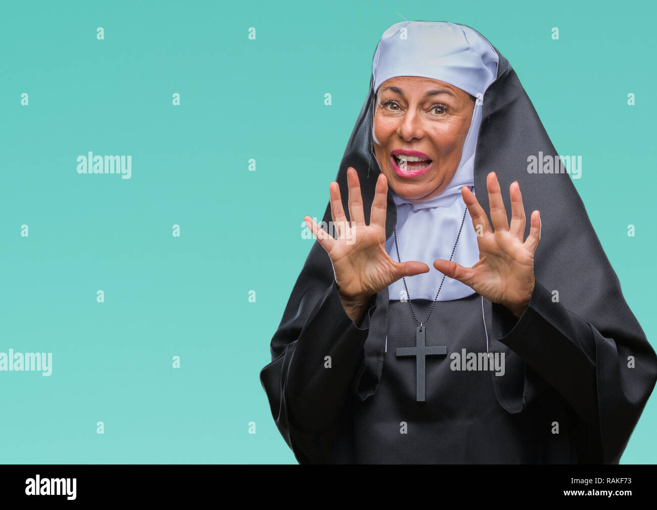 Middle age senior christian catholic nun woman over isolated background ...