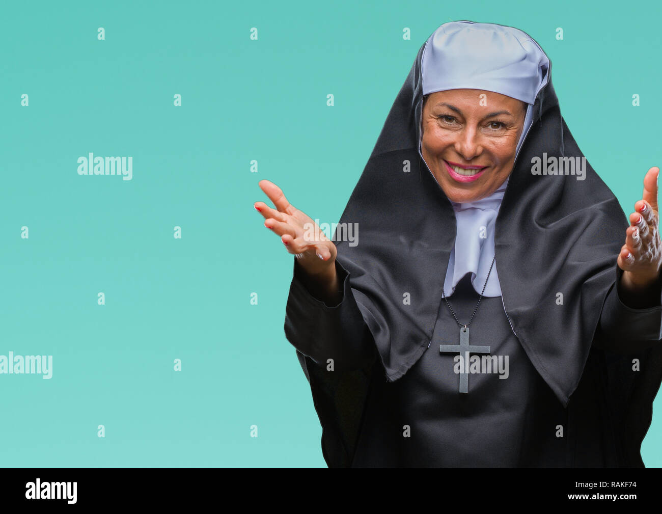 Middle age senior christian catholic nun woman over isolated background ...