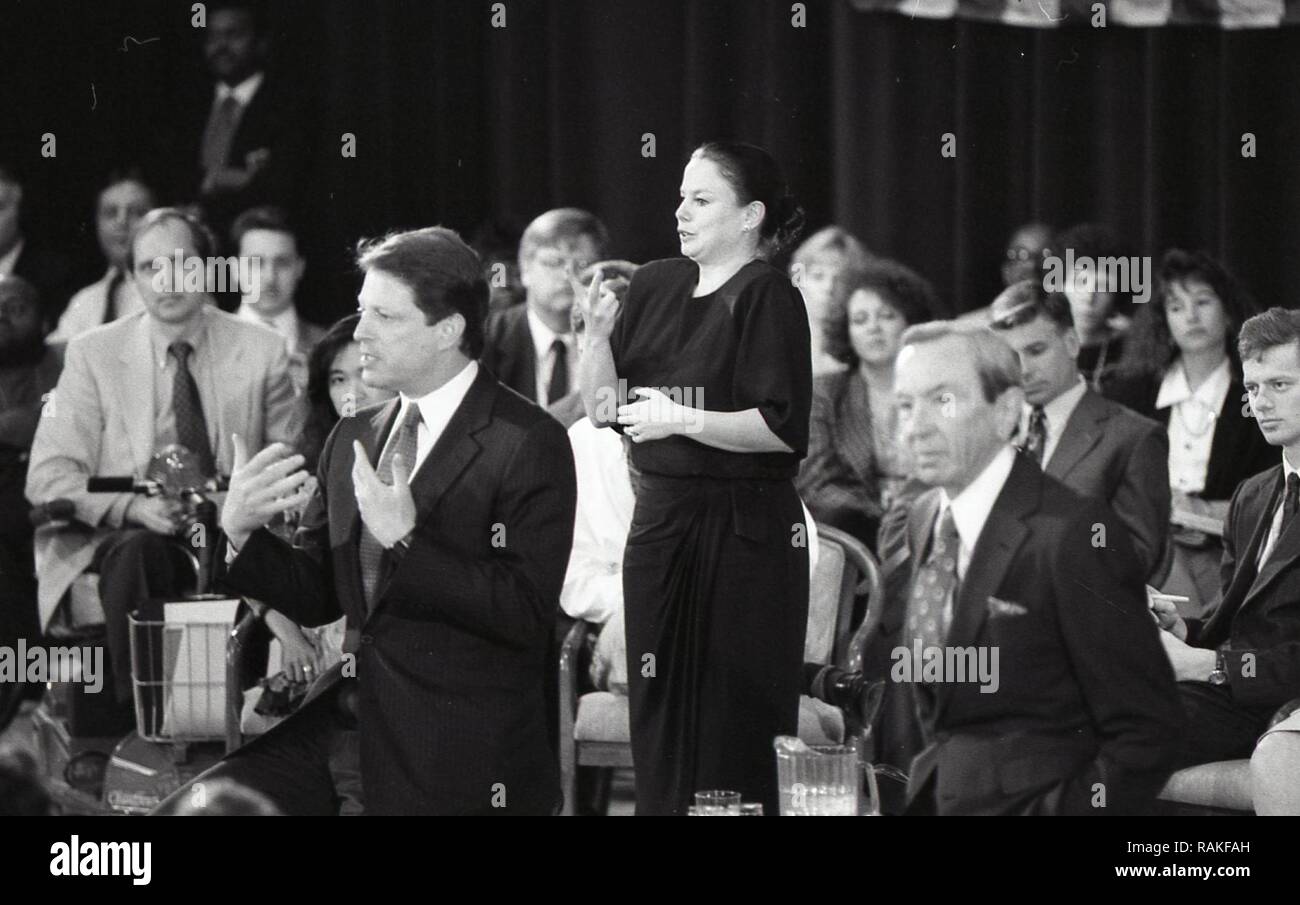 MAN TALKING TO CROWD AND WOMAN DOING SIGN LANGUAGE BEHIND HIM Stock ...