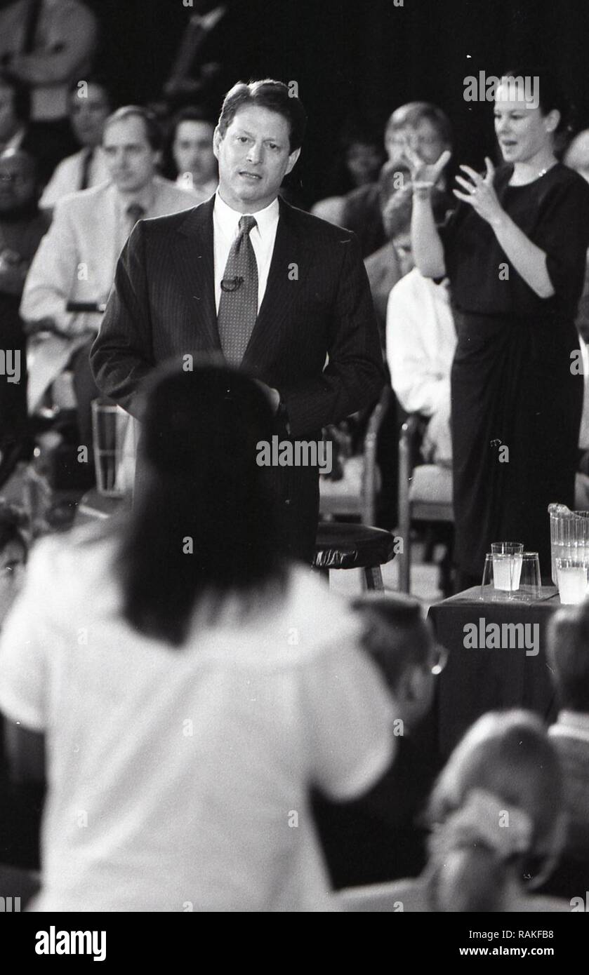 MAN TALKING TO CROWD AND WOMAN DOING SIGN LANGUAGE BEHIND HIM Stock ...