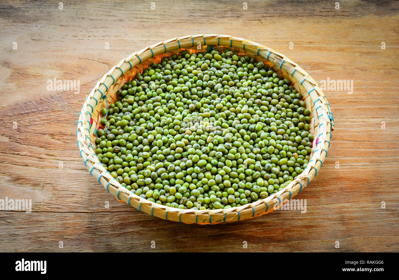 Mung beans / bamboo threshing basket with mung beans seed on wood ...