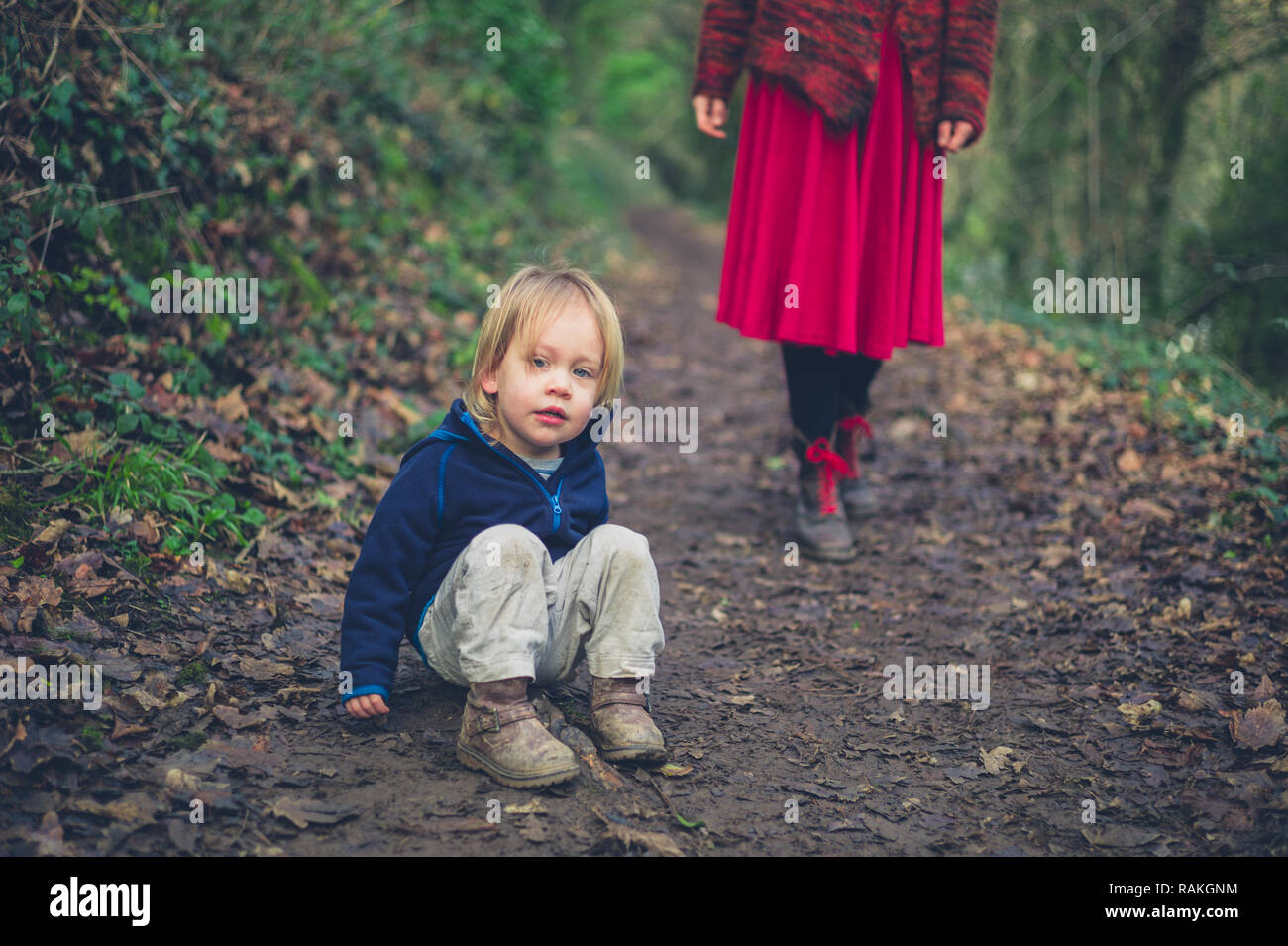 Child walking behind mother hi-res stock photography and images - Alamy