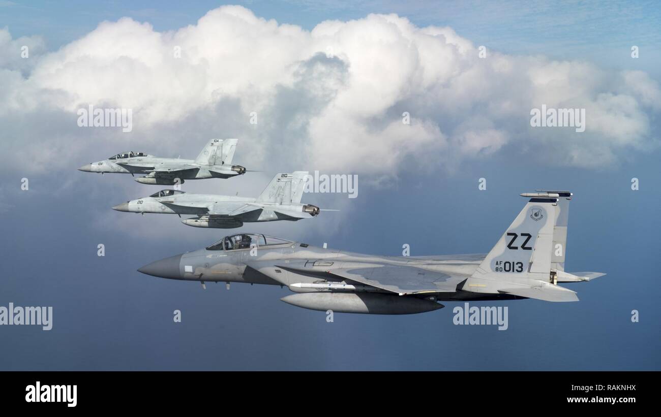 A U.S. Air Force 44th Fighter Squadron F-15 Eagle and U.S. Navy Strike Fighter Squadron 27 and ...
