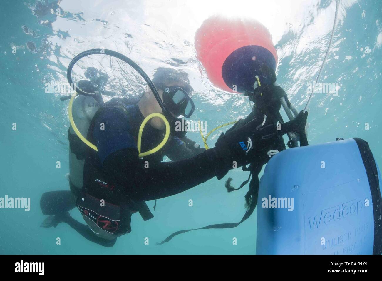 A Royal Thai Navy Explosive Ordnance Disposal diver, with the Royal ...